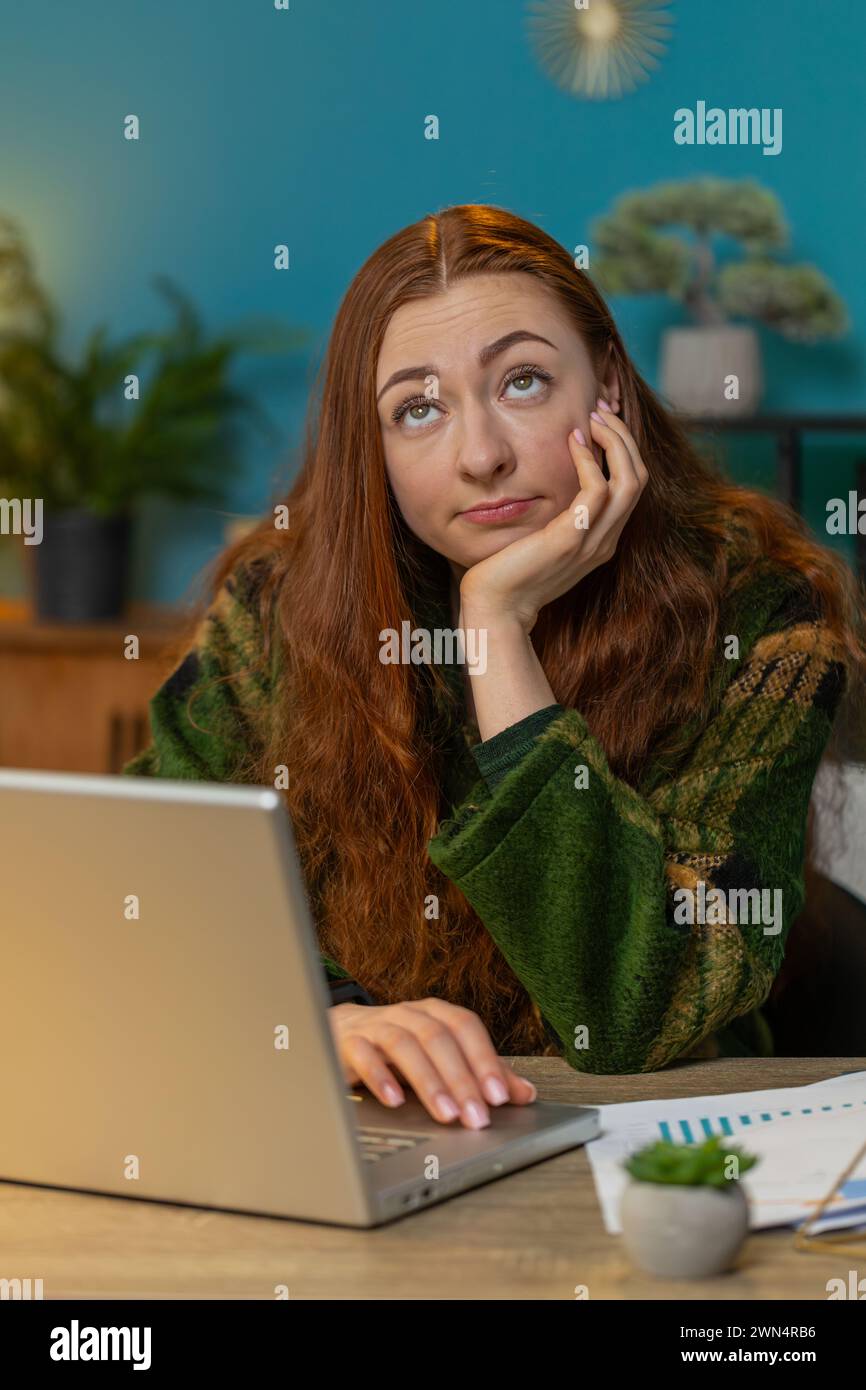 Bored sleepy businesswoman worker working on laptop computer yawns ...