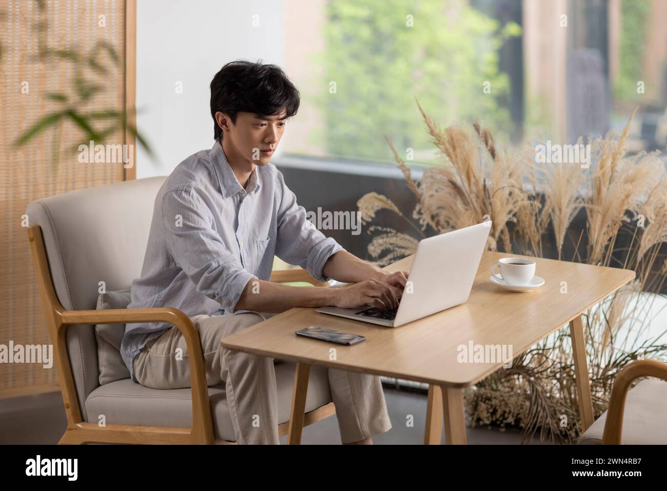 Young chinese man student using hi-res stock photography and images - Alamy