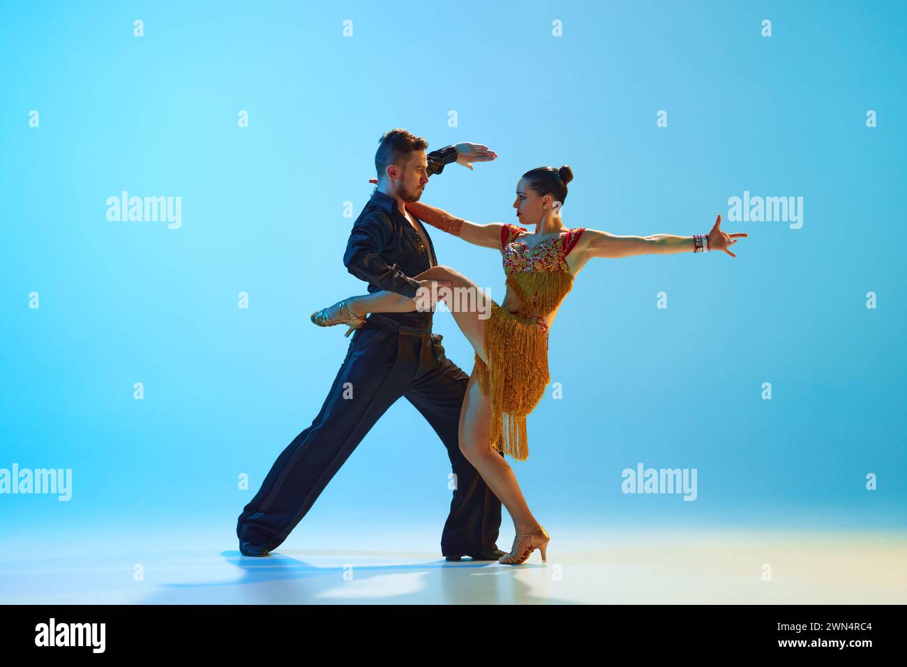 Artistic, passionate young man and woman in motion, dancing ballroom ...