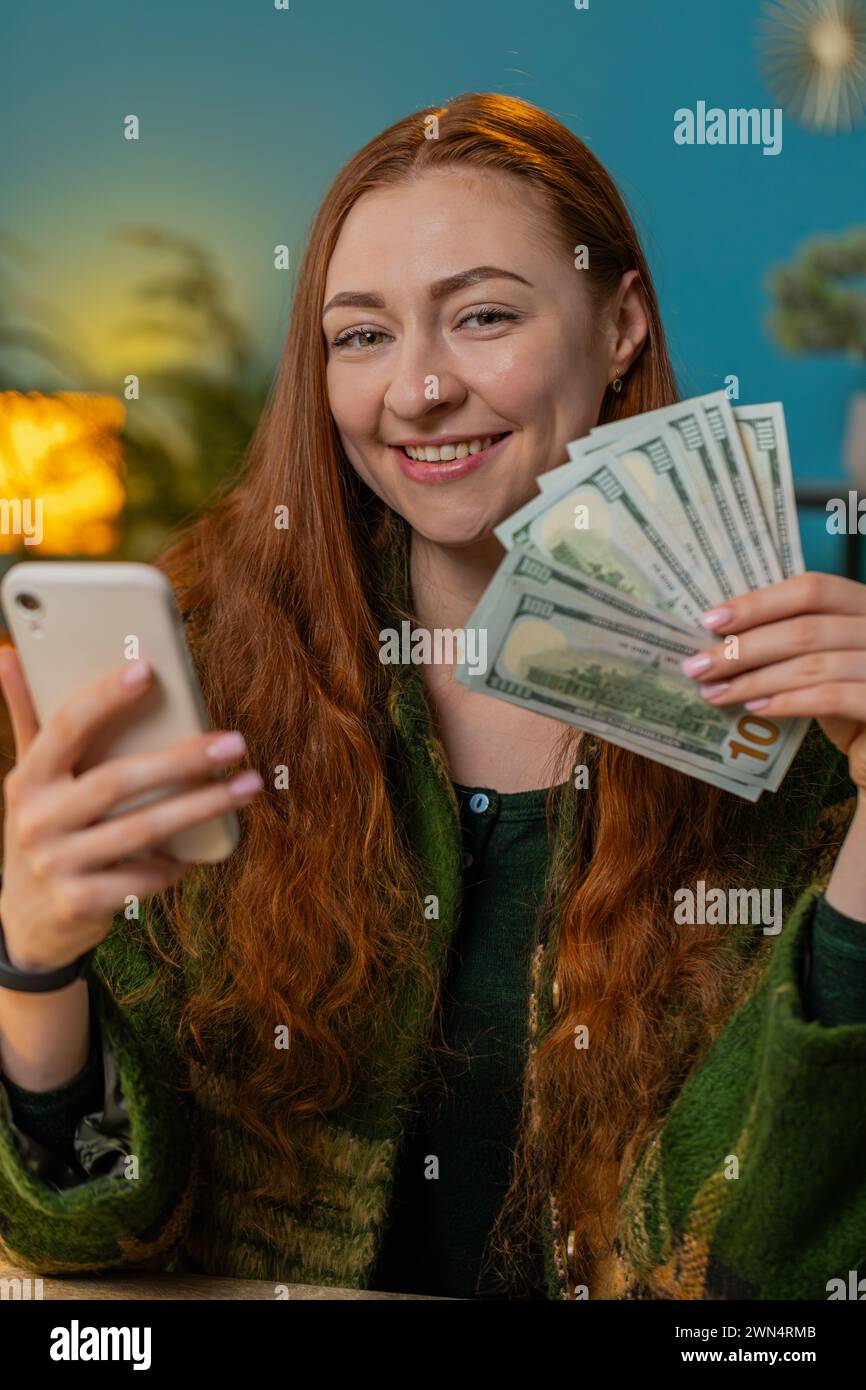 Planning family budget. Smiling happy Caucasian woman counting money ...