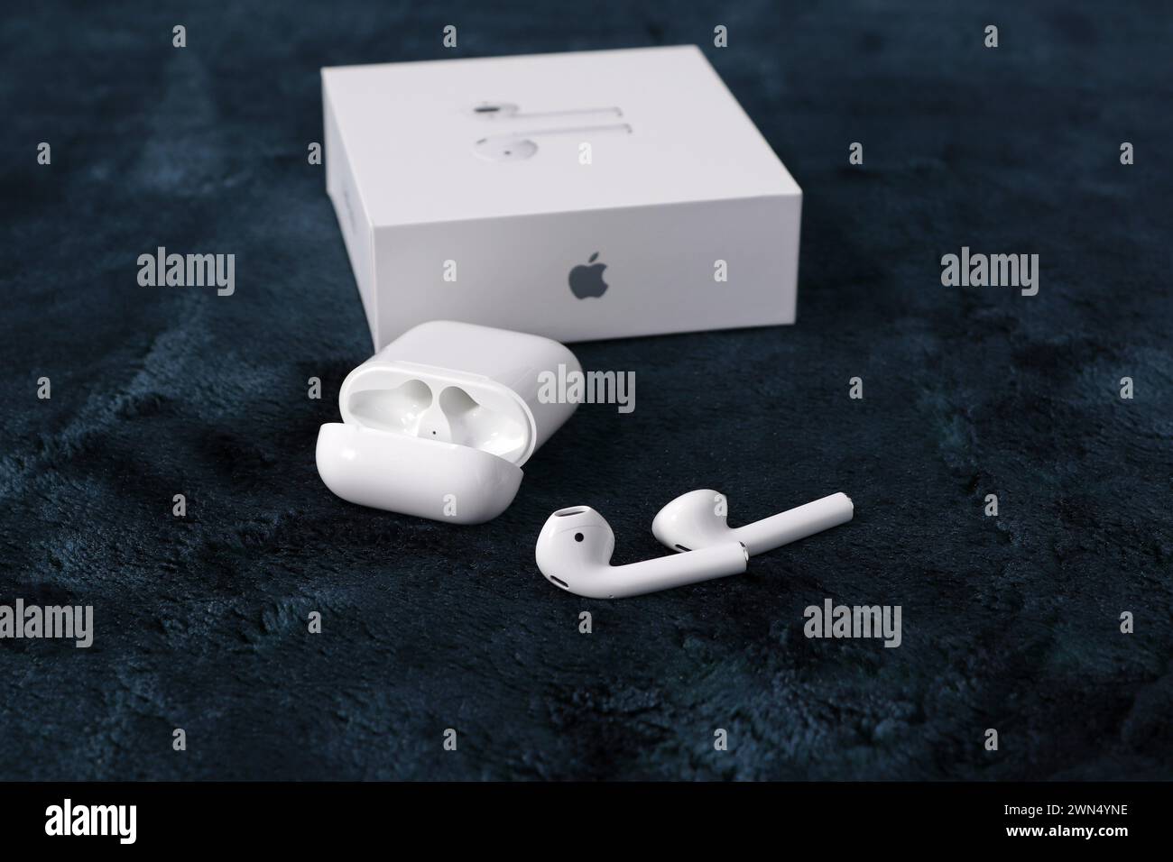 Apple wireless headphones with a packaging box on a dark background ...