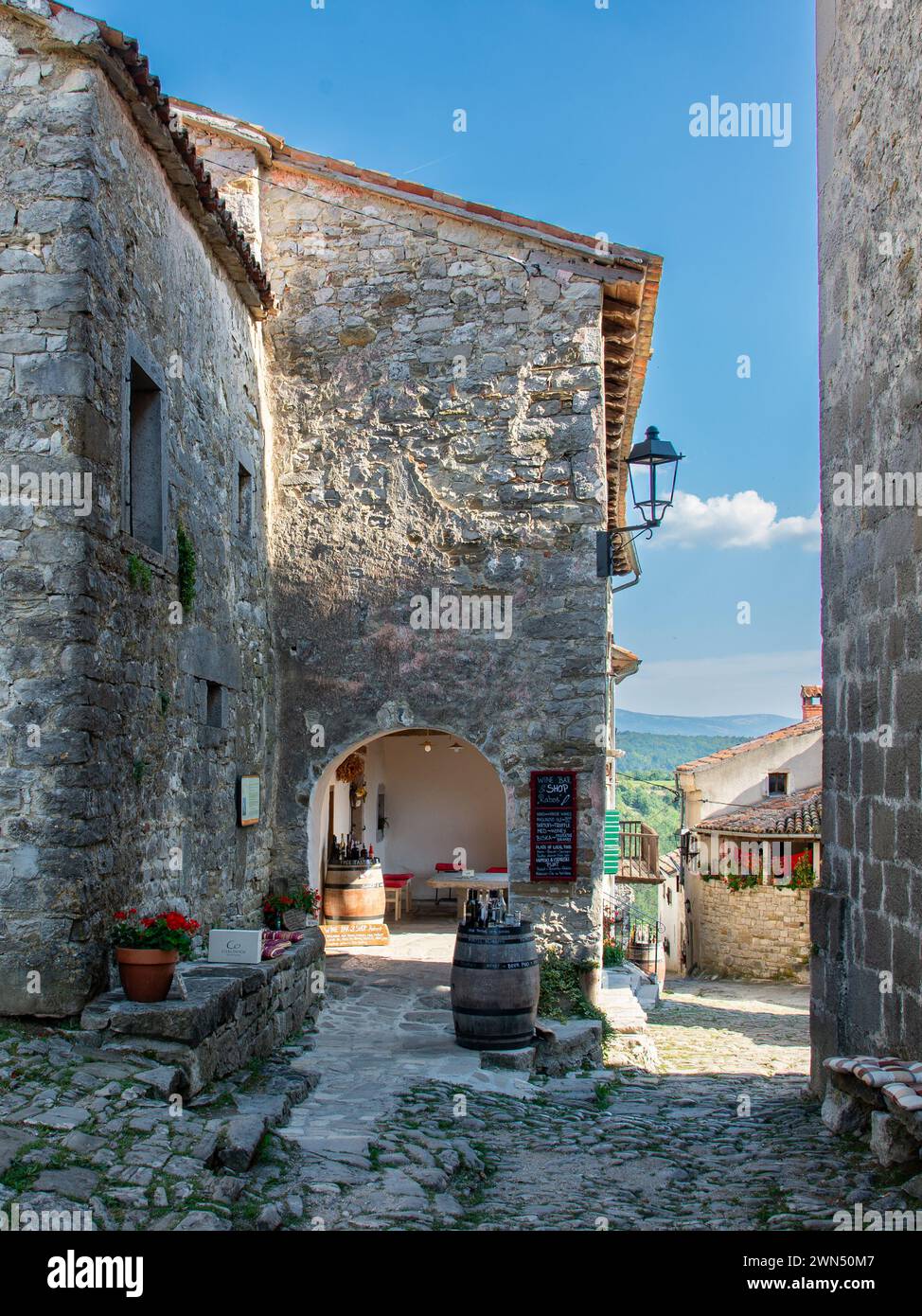 Bottles of local alcohol displayed on a barrel in front of a shop ...