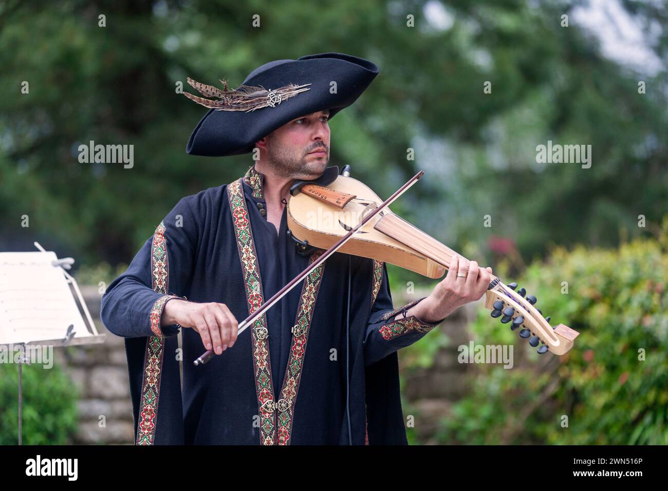 Locronan, France - May 07 2023: Troubadour in medieval attire playing ...