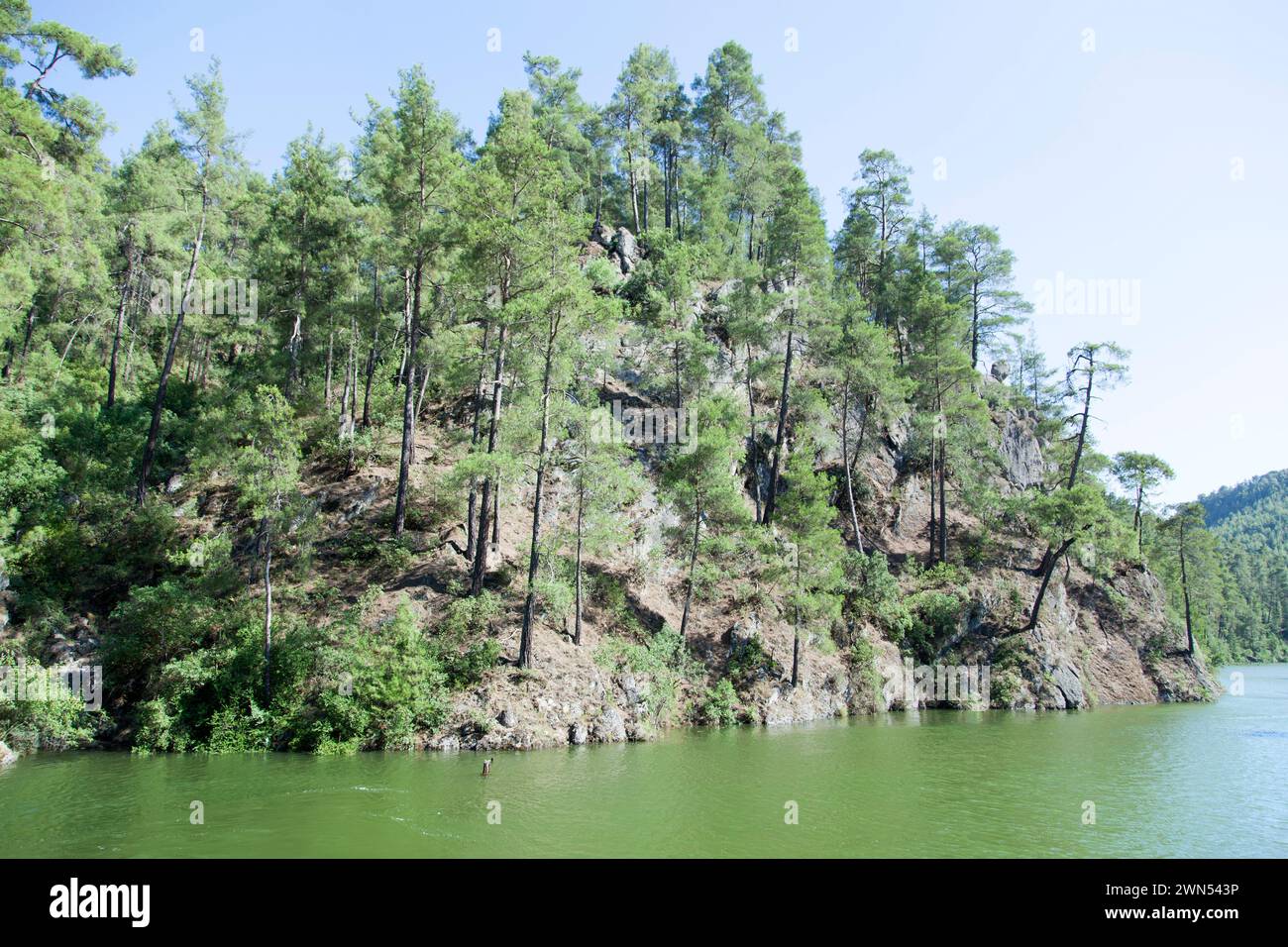 The scenic view of green color Karacaoren Lake and steep coastline with ...