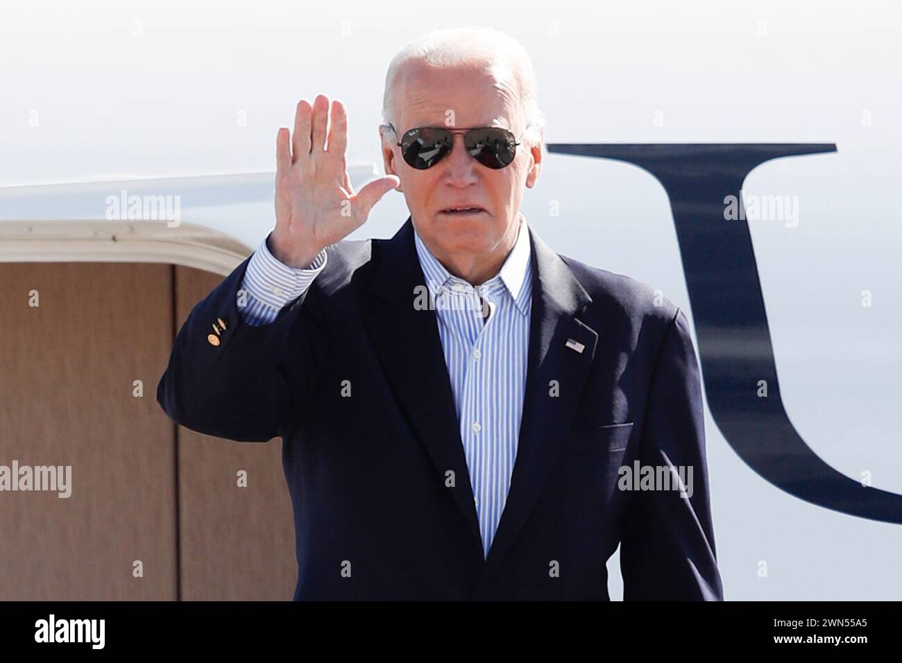 President Joe Biden waves from the stairs of Air Force One, Thursday ...