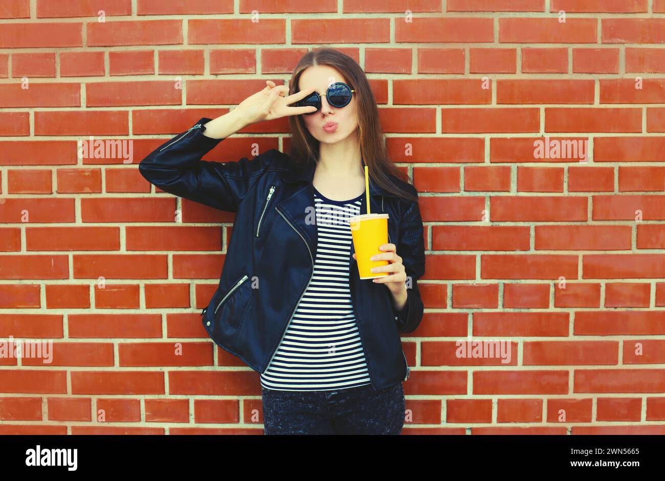 Portrait of stylish young woman model wearing black leather jacket in ...
