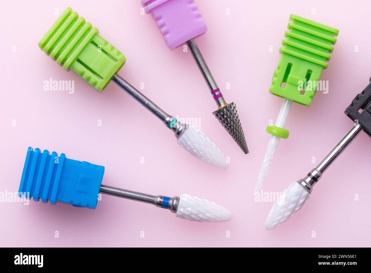 Five different cutters for hardware manicure and pedicure on a colored ...