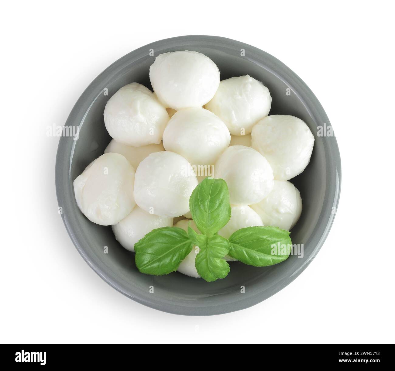 Mini mozzarella balls with basil in a ceramic bowl isolated on white ...