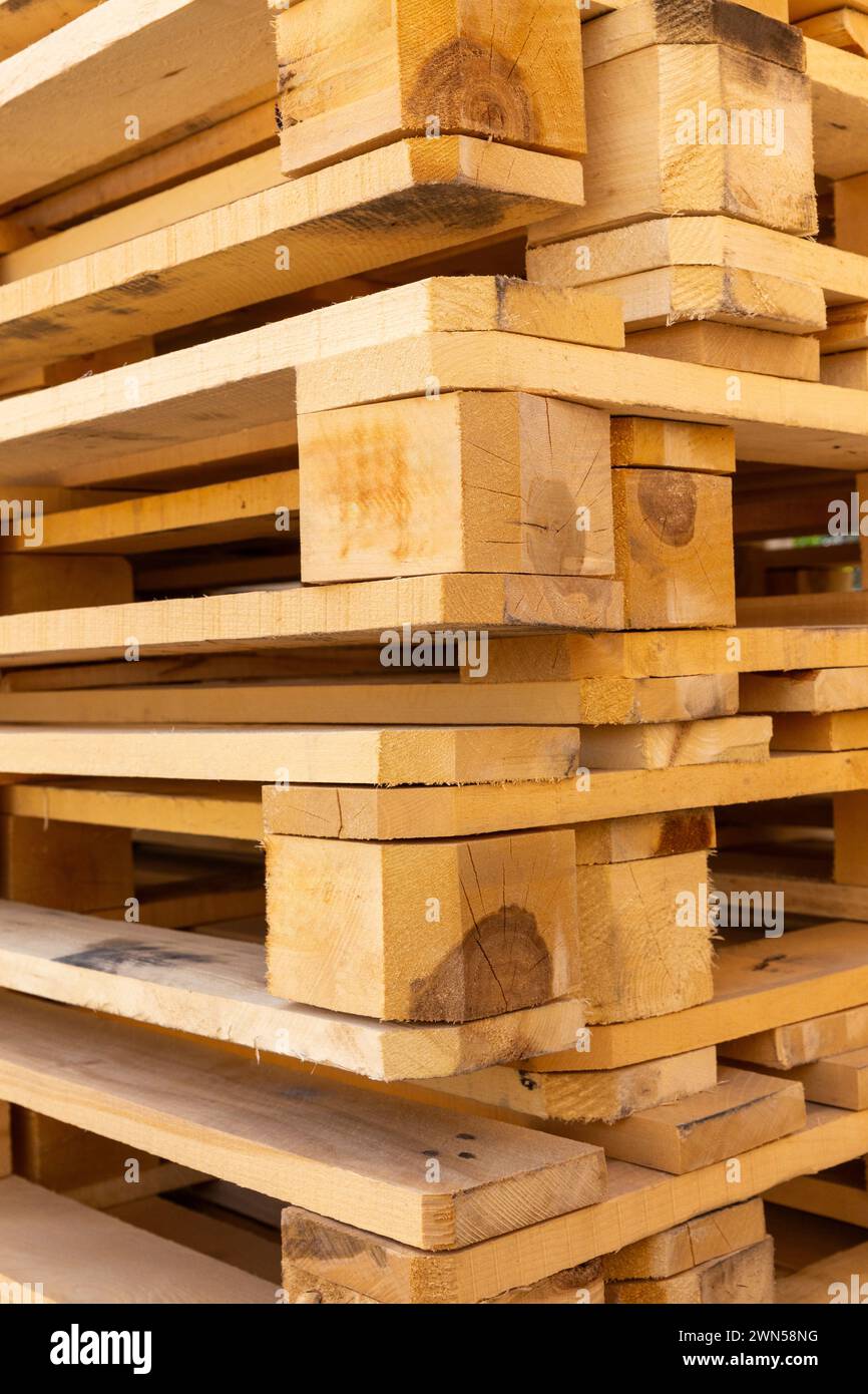 Piles of stacked natural wooden shipping pallets. Outside a big stack ...