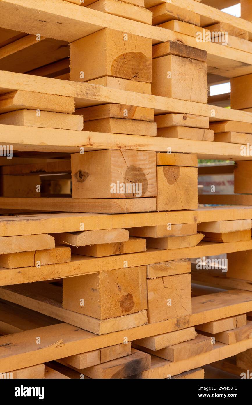 Piles of stacked natural wooden shipping pallets. Outside a big stack ...