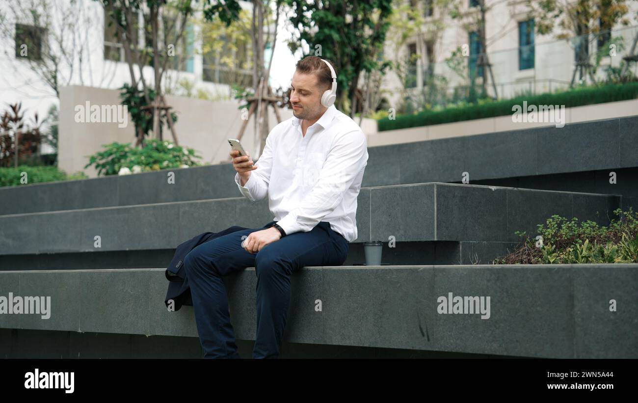 Smart businessman wear headphone to listen relaxed music while take off ...