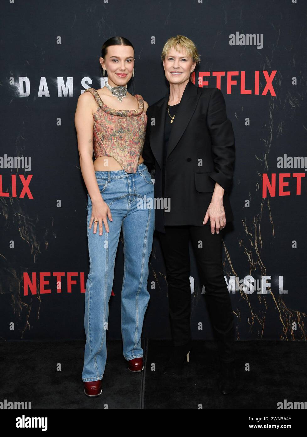 Actors Millie Bobby Brown, left, and Robin Wright pose together at the ...