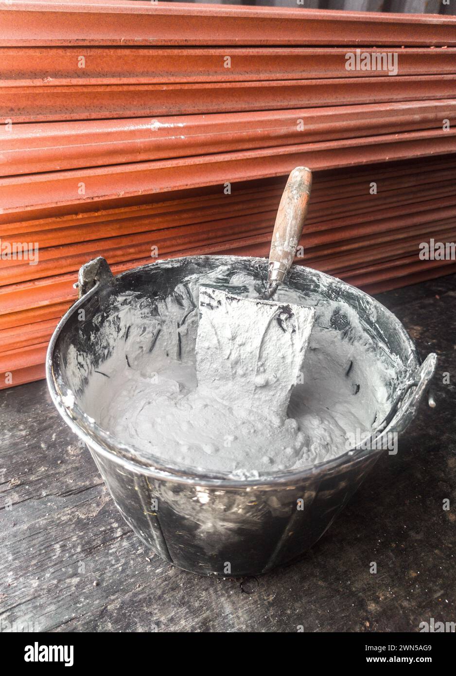 Bucket full white adhesive mortar ready for applicate. Large thin ...