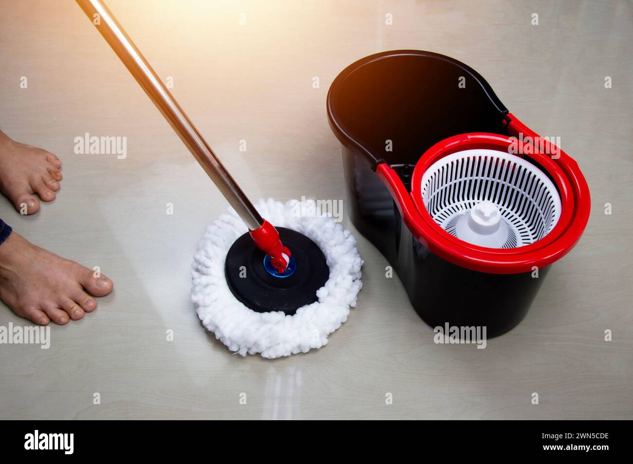 The housekeeper is mopping the floor and cleaning Stock Photo - Alamy