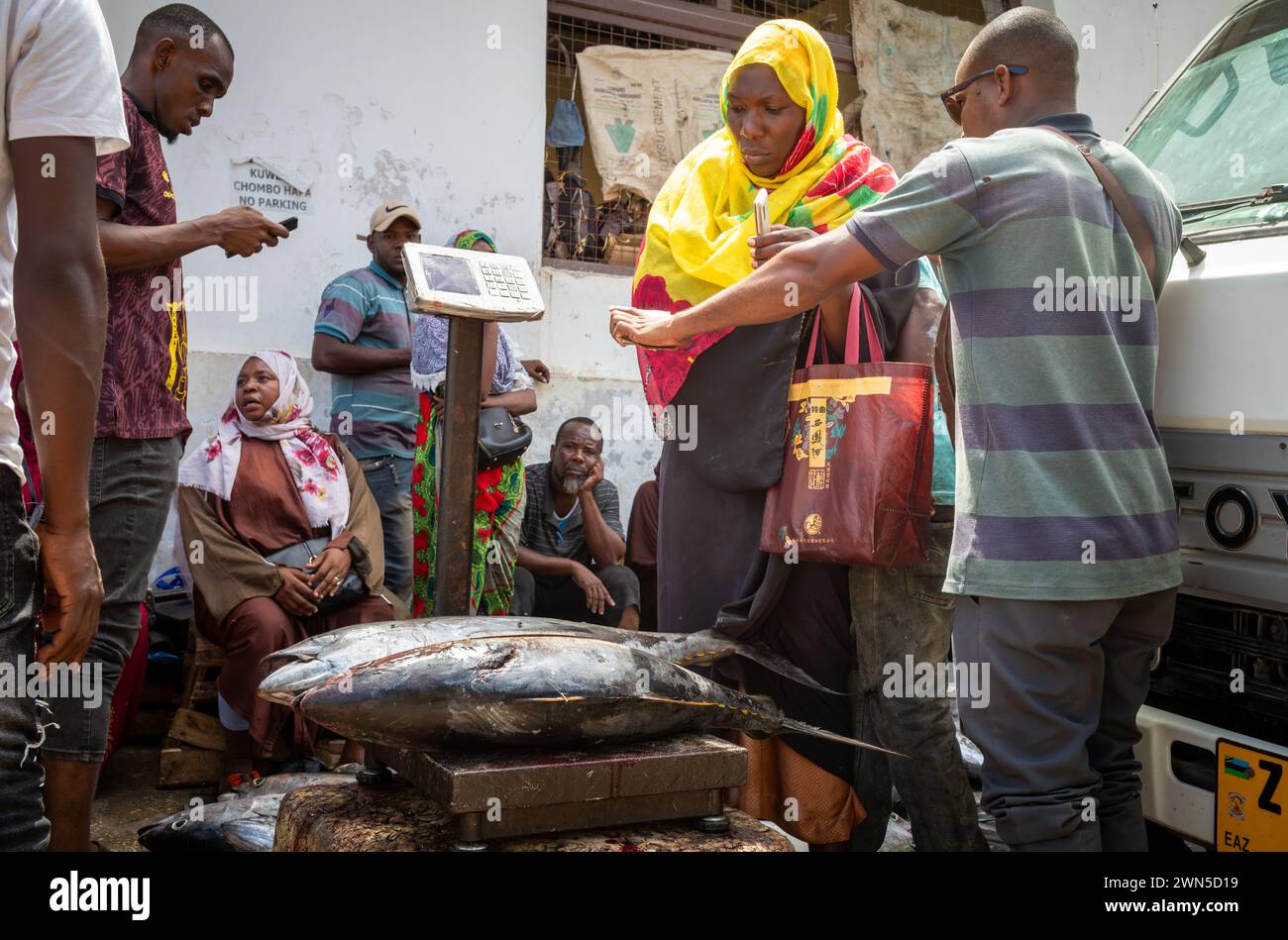 A woman buys Yellowfin tuna (Thunnus albacares) in the street at Stone ...