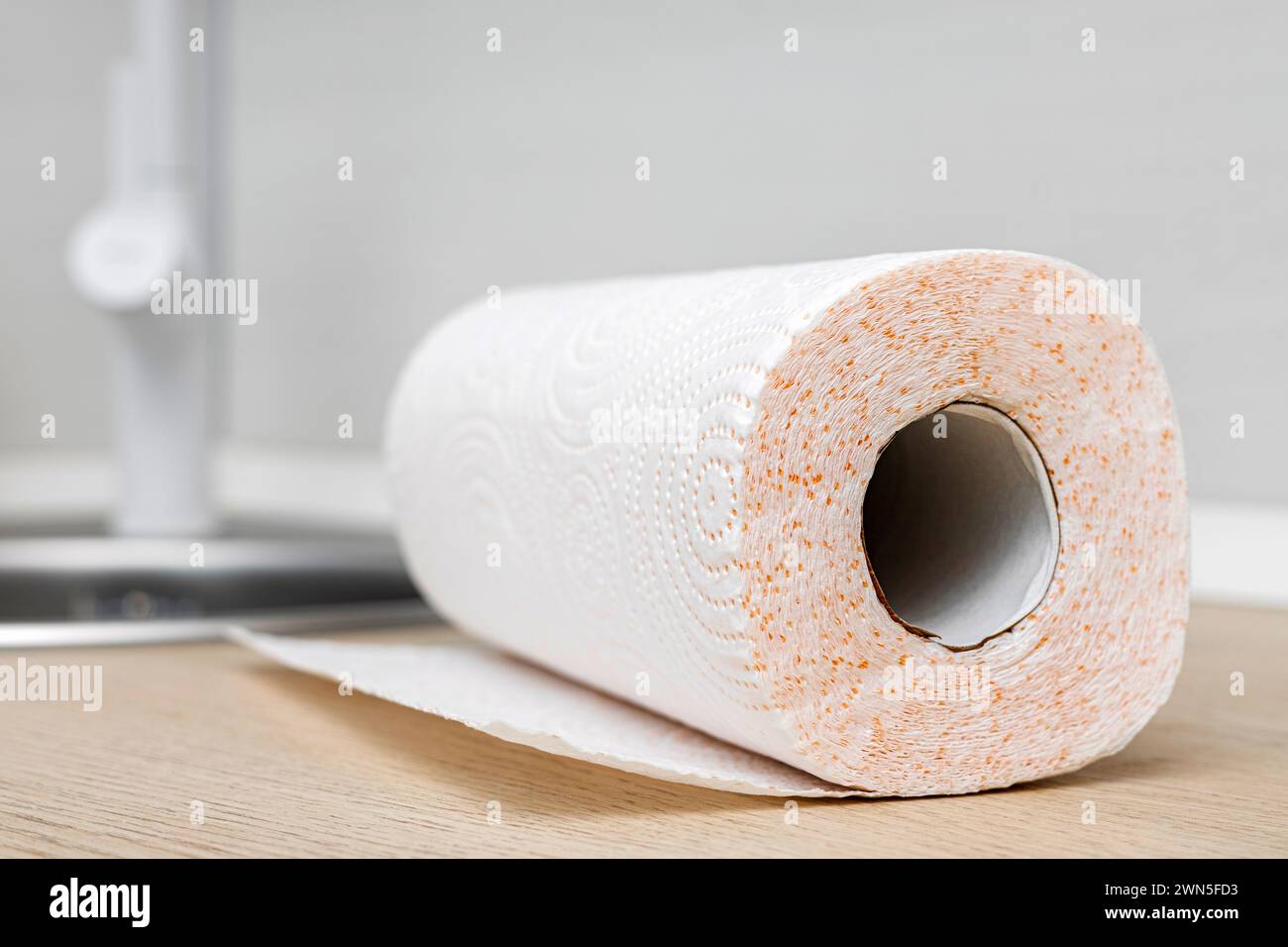 a roll of paper towel lies on the kitchen counter. paper towel in the ...