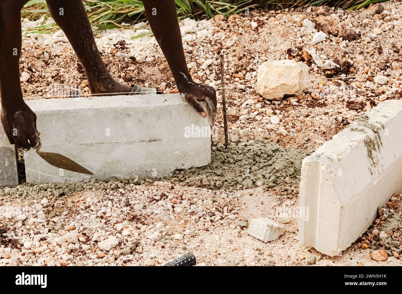 Chowel Tapping Side Of Concrete Block To Align Stock Photo - Alamy