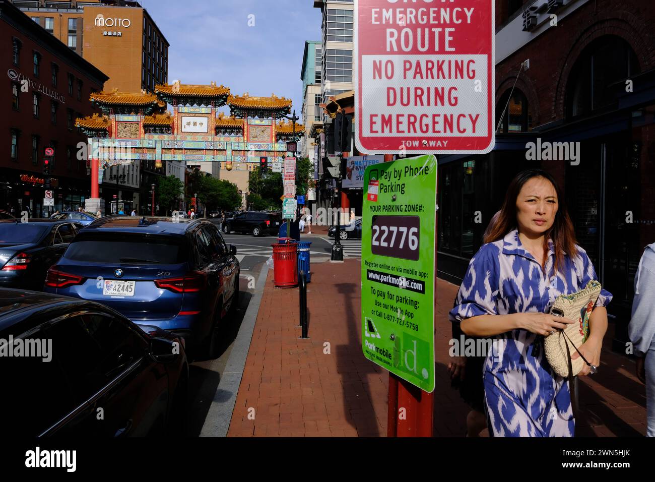 Pedestrians on the street with Friendship Arch of Chinatown in ...