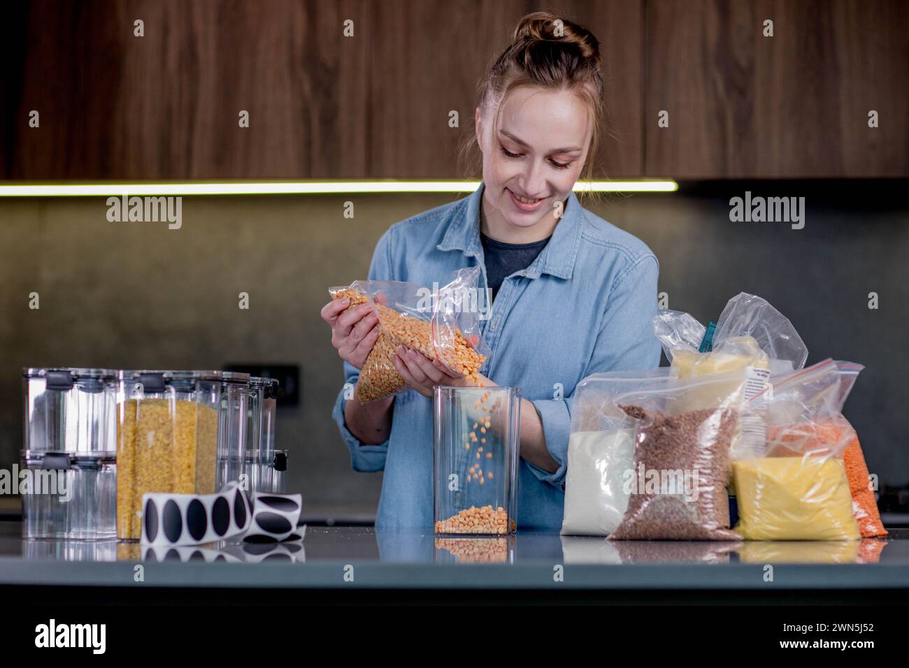 Layout and sorting of food products. Woman uses containers to organize ...