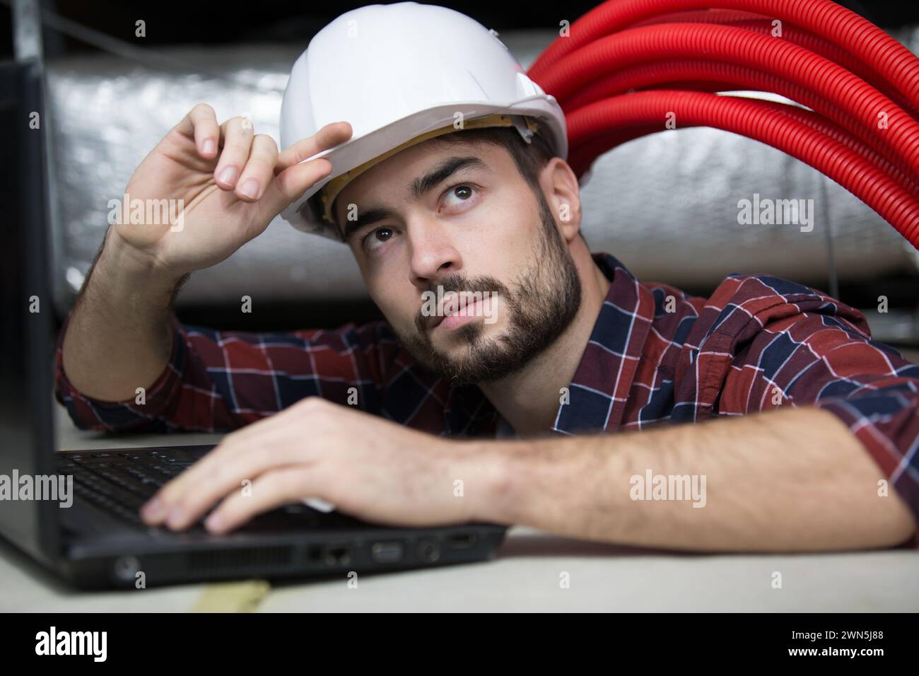 skilled male engineer with laptop looking for problem Stock Photo - Alamy