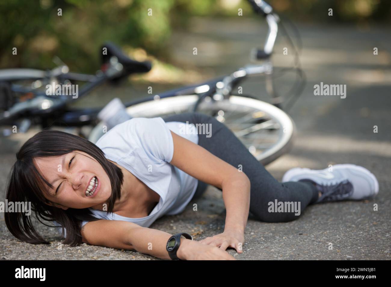 young woman fell off mountain bike Stock Photo - Alamy