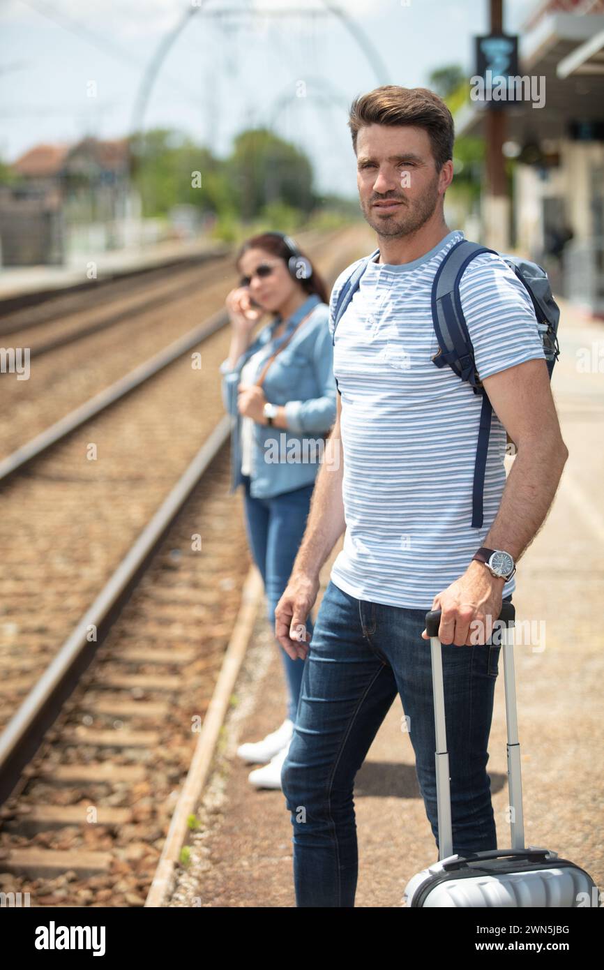 people waiting for train at railway departures Stock Photo - Alamy