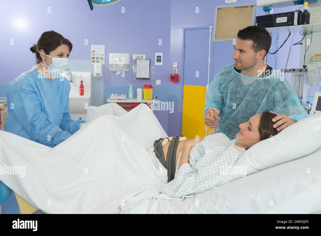 medical team husband and wife during delivery in operating room Stock ...
