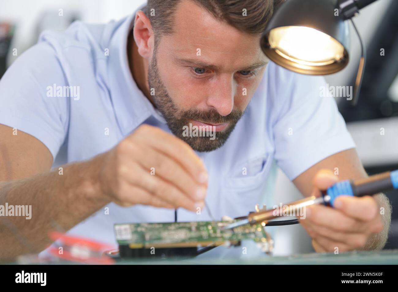 Male tech repairs electronic equipment hi-res stock photography and ...