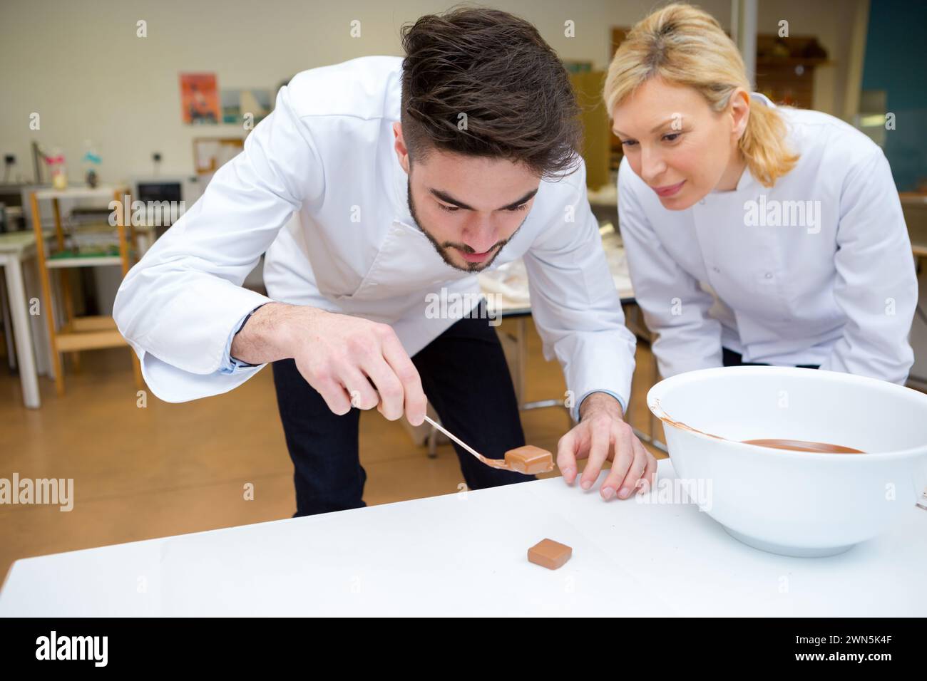 female and male chefs making caramel Stock Photo - Alamy