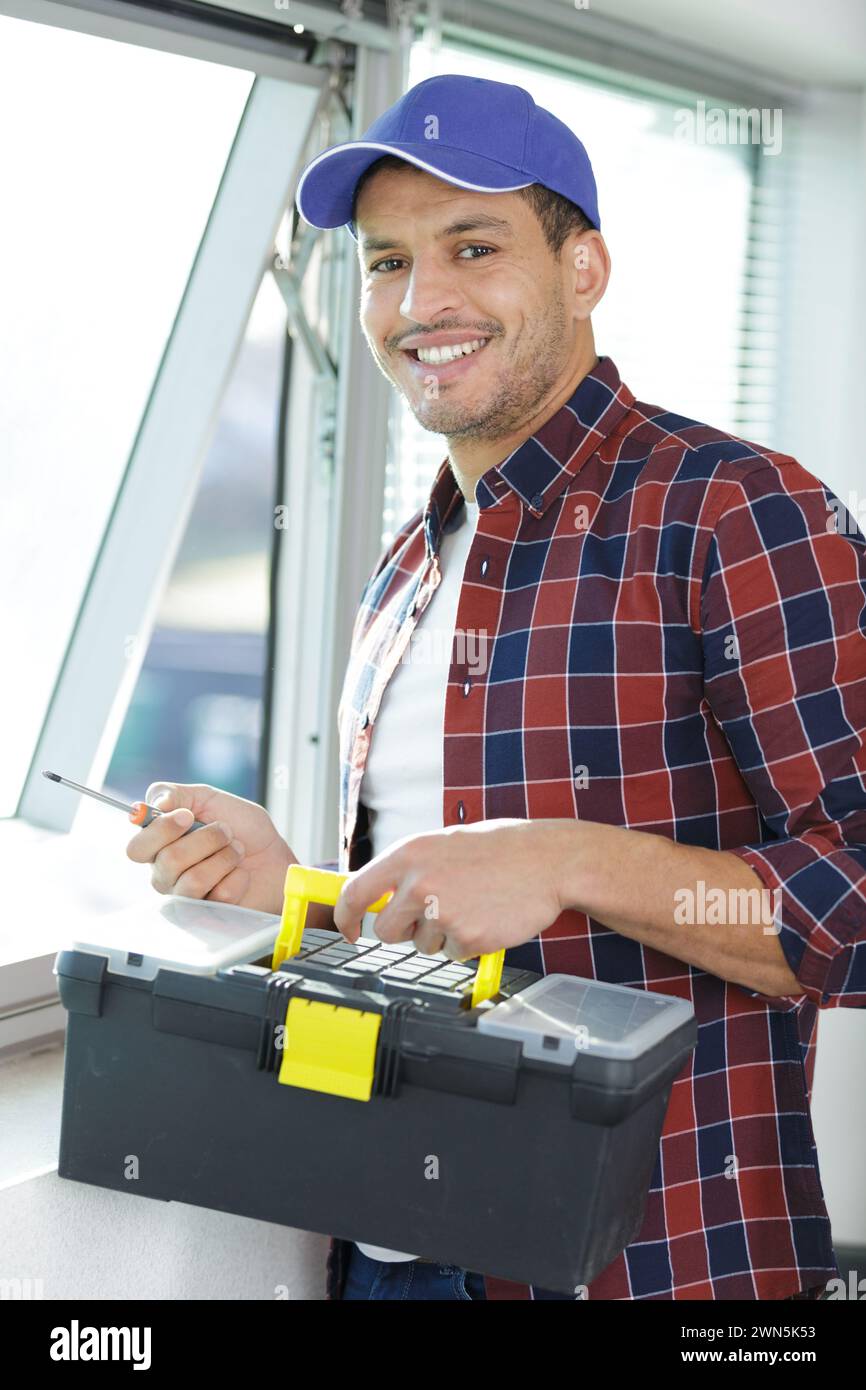 Maintenance worker fixing a window hi-res stock photography and images ...