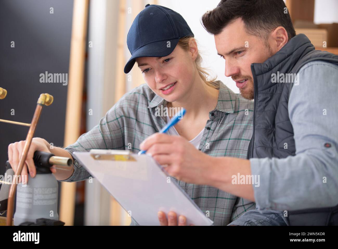 engineers reading clipboard while working in temperature control-room ...