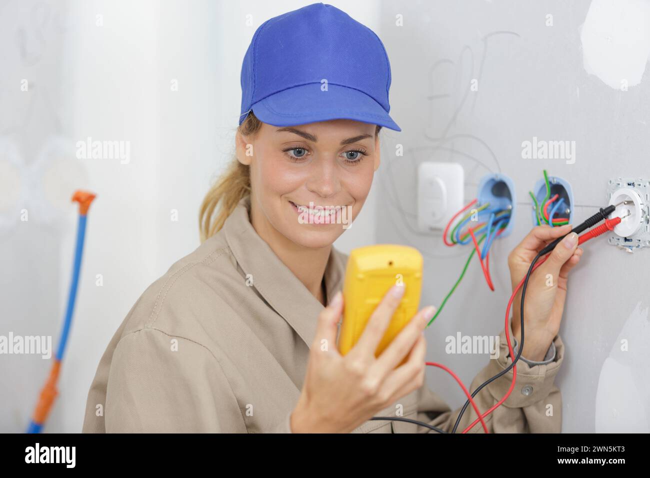 female electrician testing a wall socket Stock Photo - Alamy
