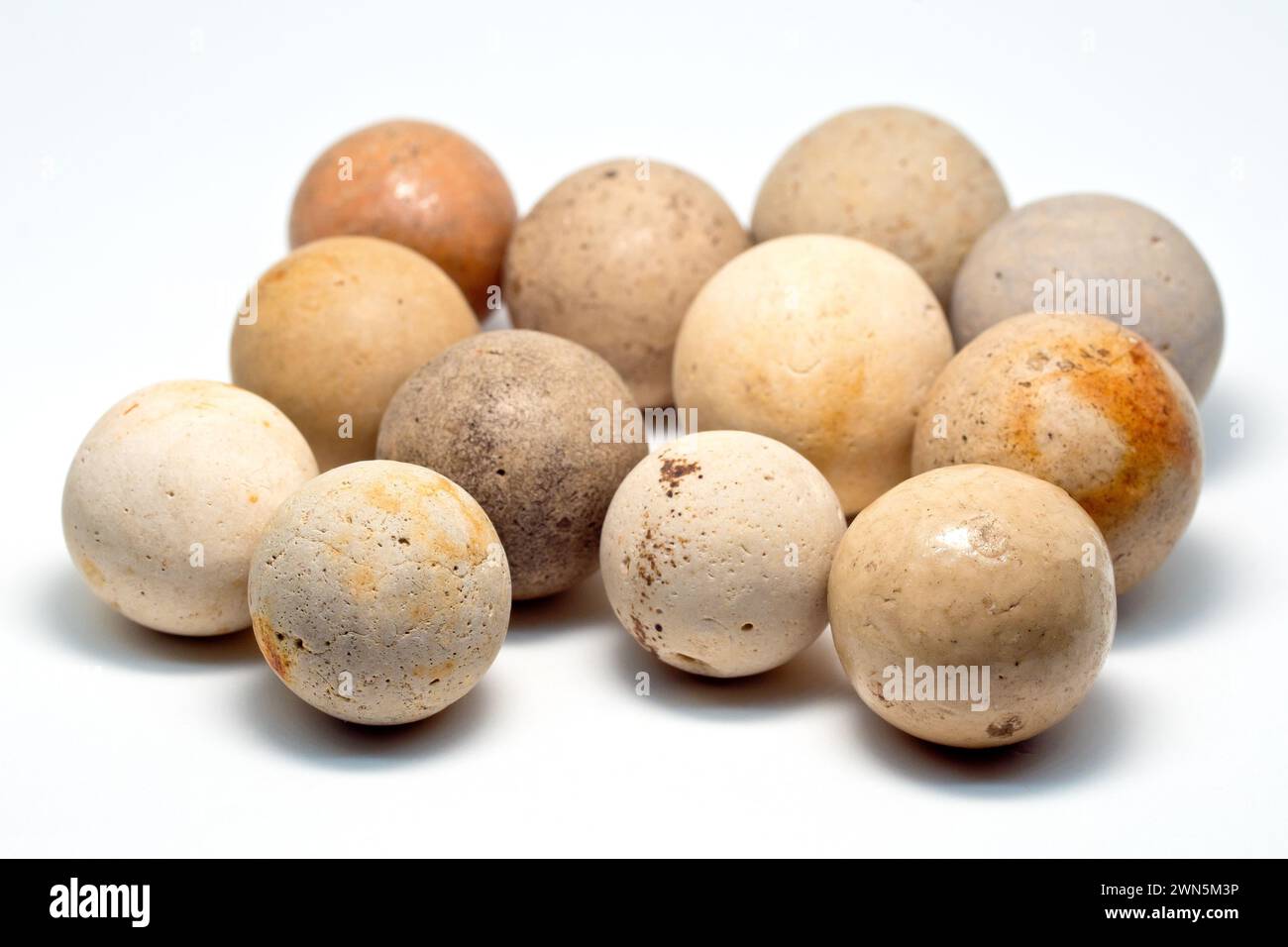 Close up of several old clay pottery marbles, locally known as cheesers ...