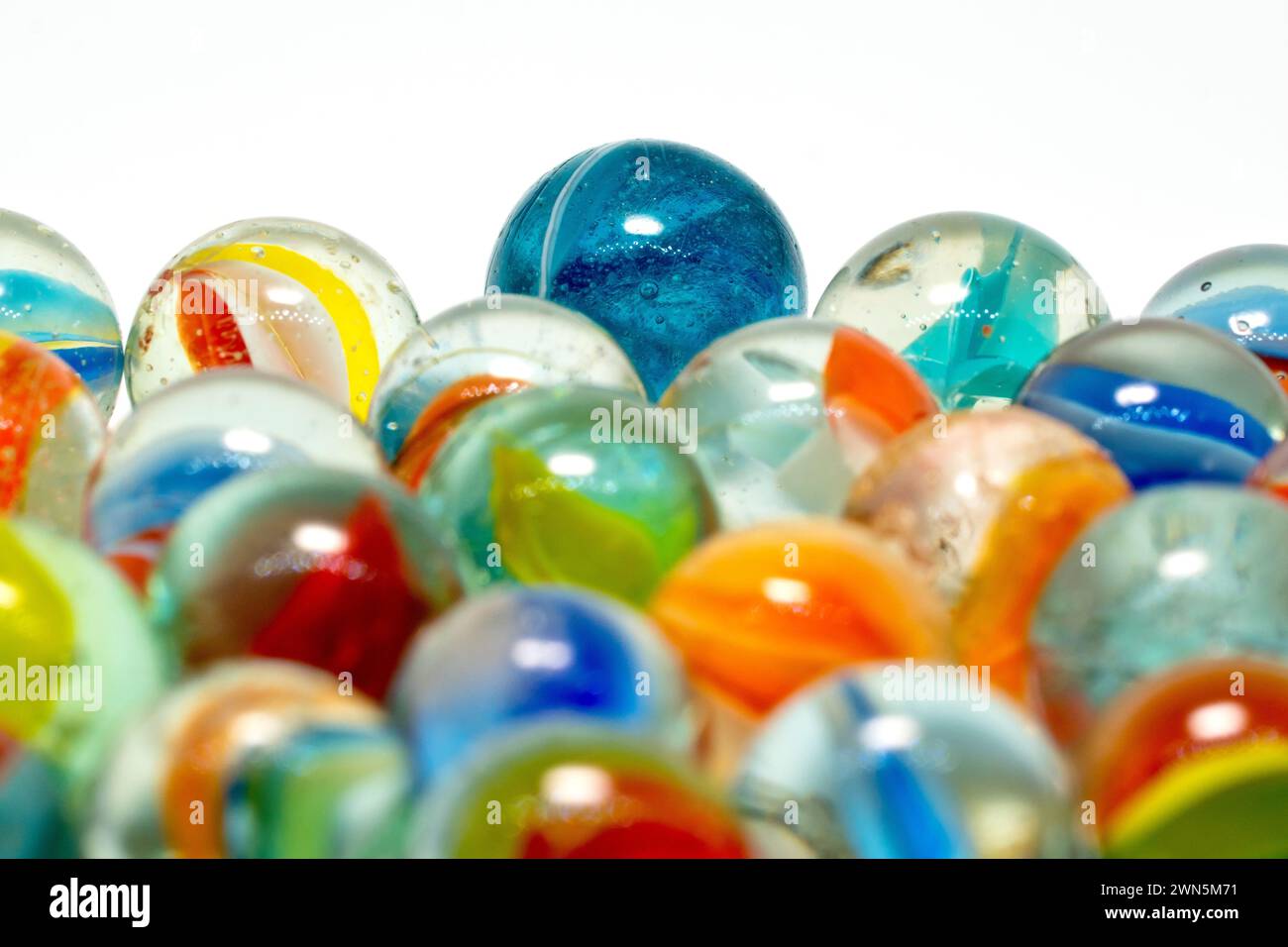 Close up of several colourful glass marbles, a popular toy or game ...