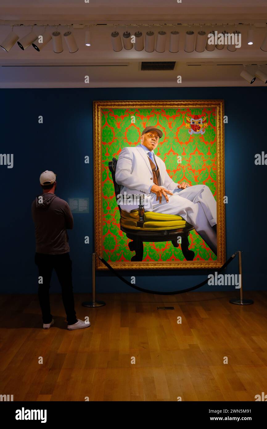 A visitor looking at the oil painting LL Cool J by artist Kehinde Wiley ...