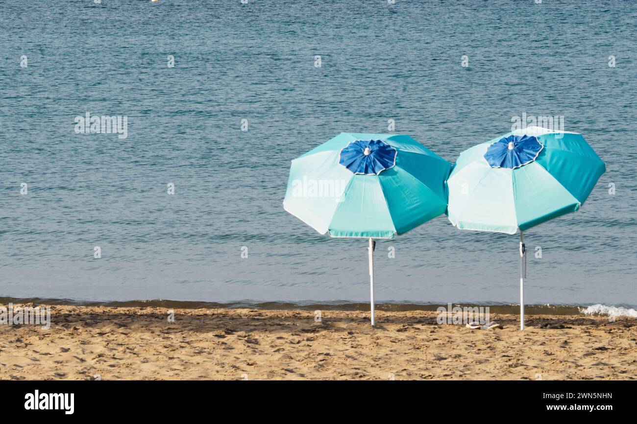 Two umbrellas on the beach Stock Photo - Alamy