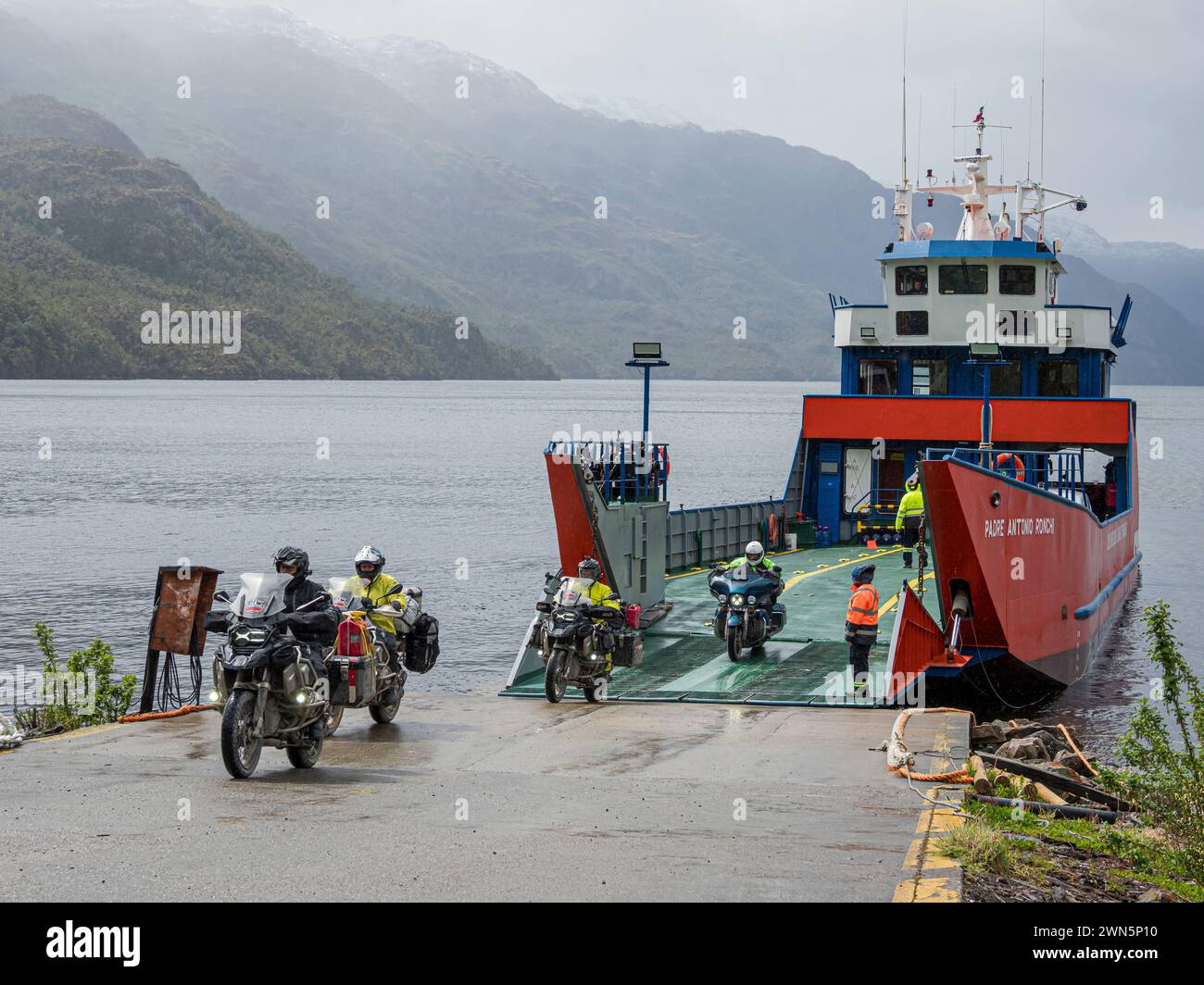 A group of motorcycles leaves the at Caleta Yungay on a rainy day ...