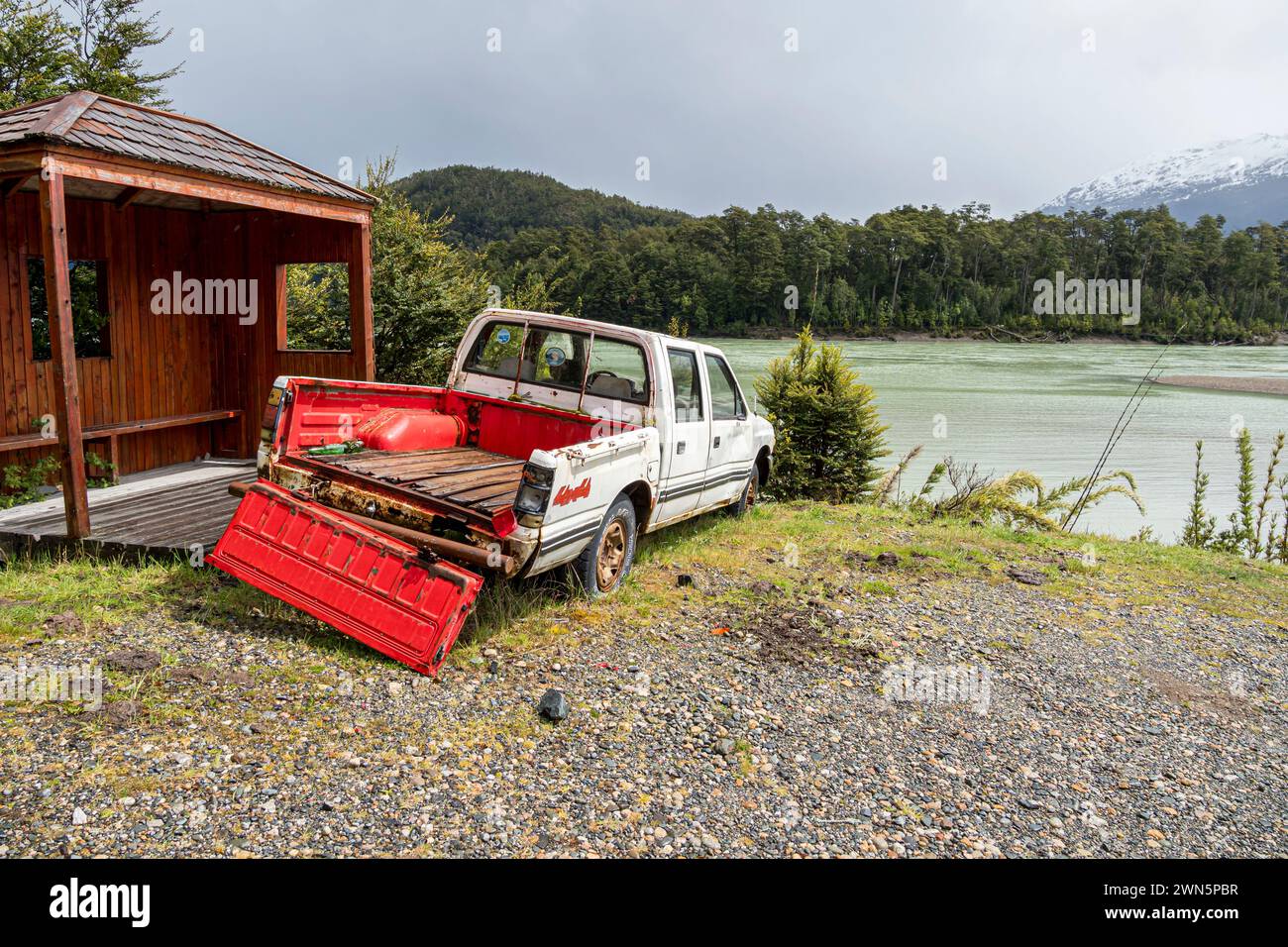 Wrack of a pickup at river Rio Baker upstream of village Caleta Tortel ...