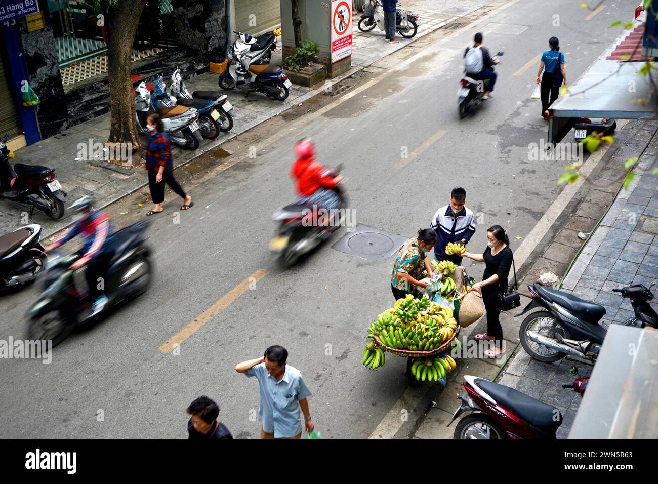Extremely busy streets in old town of Hanoi, with bikes and food ...