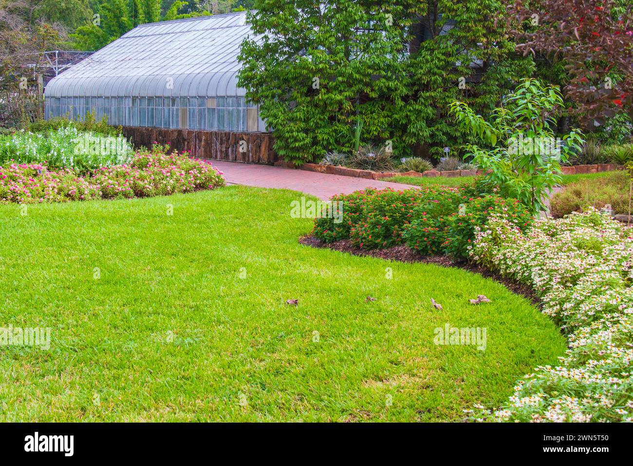Garden path and greenhouse in Mercer Arboretum and Botanical Gardens in ...