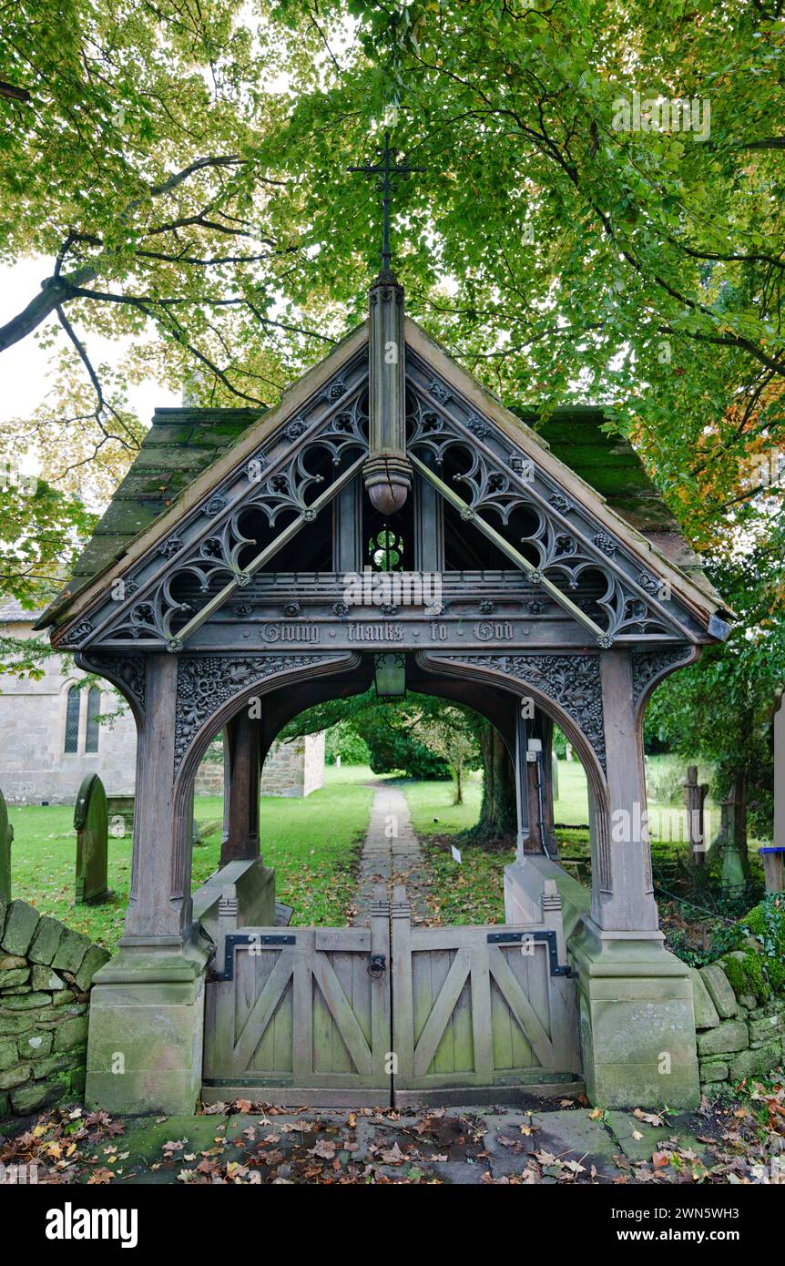 Ornate oak entry gate to an Anglo Saxon church with path visible behind ...