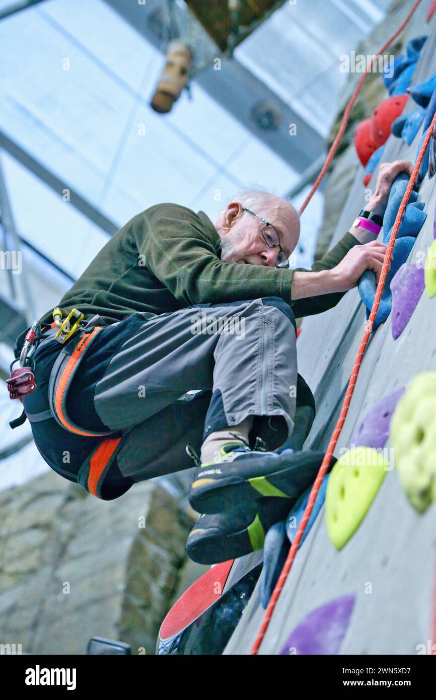 Working way up climbing wall Stock Photo - Alamy