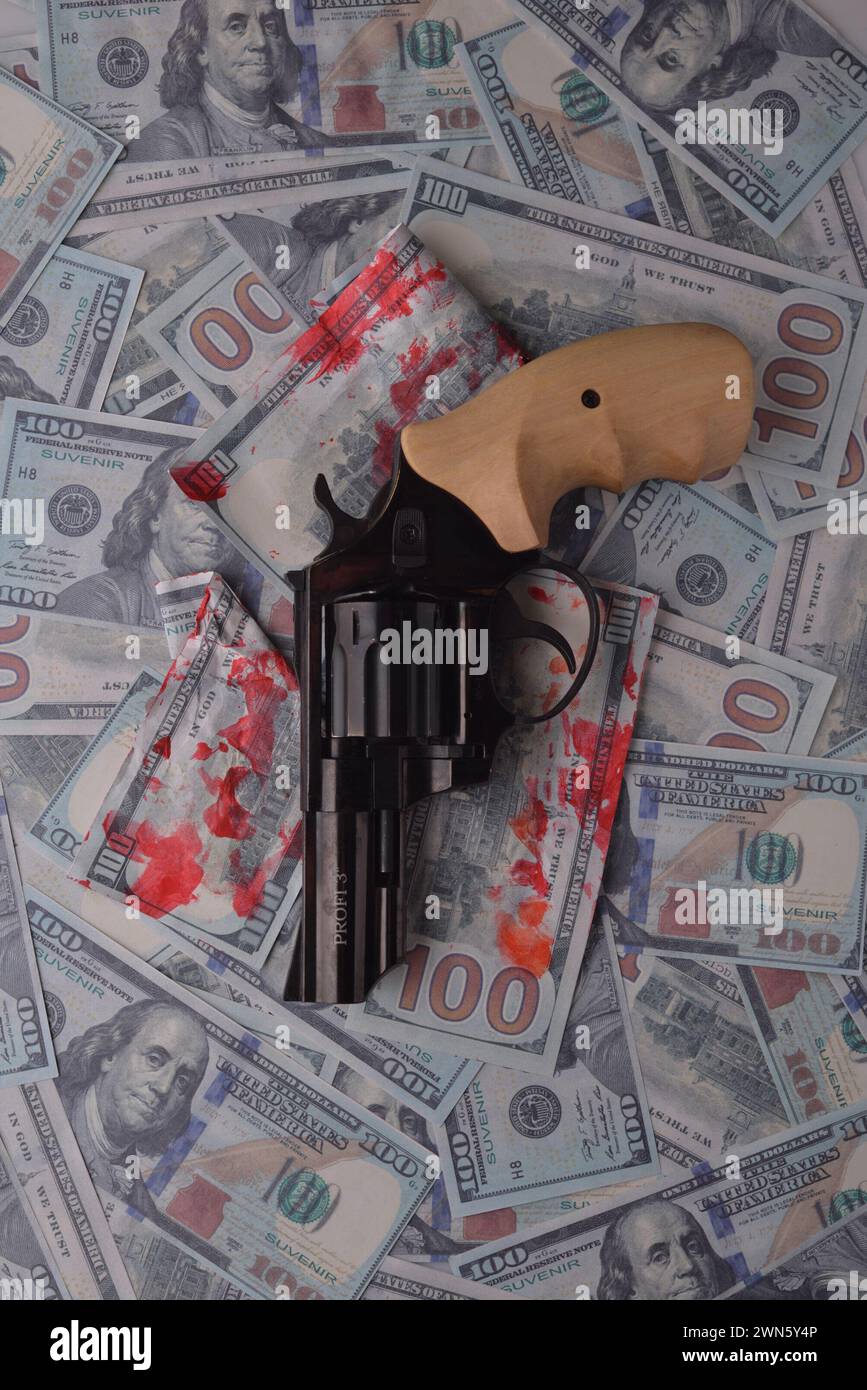 gun on bloody dollar bills blood money murder Stock Photo - Alamy