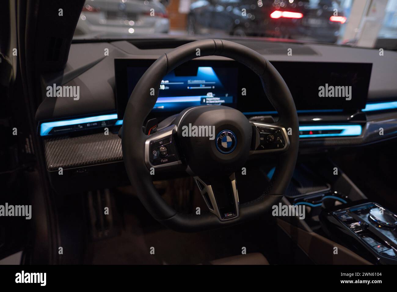 Interior, cockpit of BMW i5 eDrive40 car, digital panel, instruments on steering wheel, EV ...