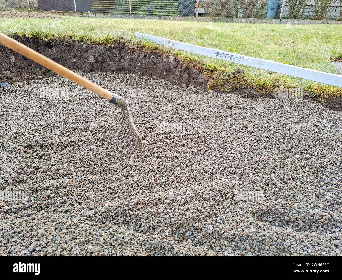 Laying gray concrete paving slabs in house courtyard driveway ...