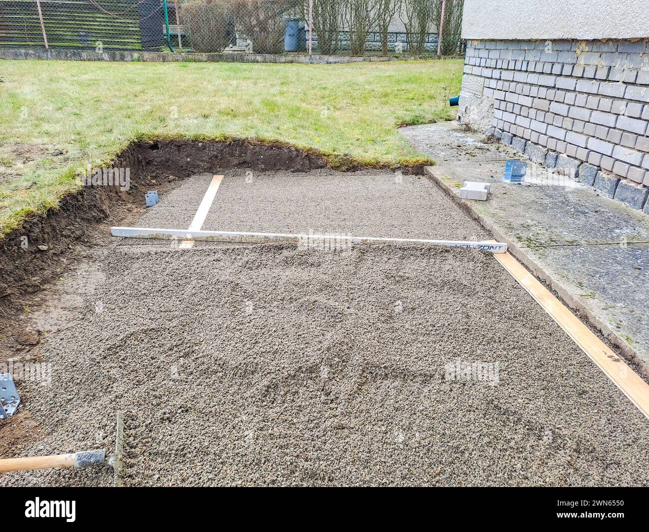 Laying gray concrete paving slabs in house courtyard driveway ...