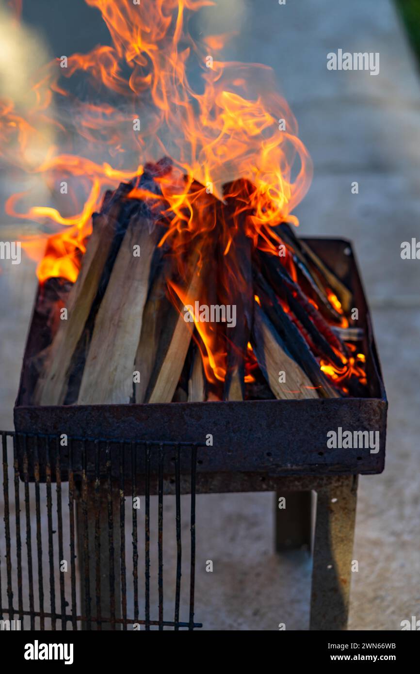 Burning wood chips to form coal. Barbecue preparation, fire before ...
