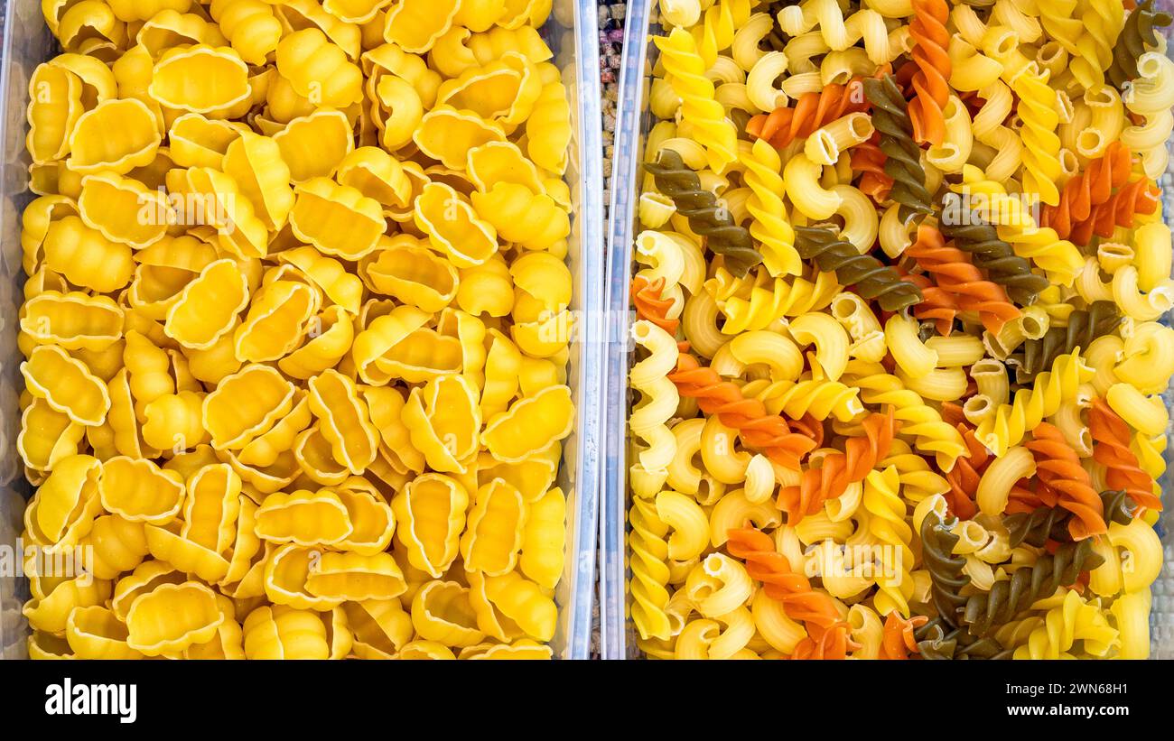 Different types of raw Italian pasta (gnocchi, tricolor pasta) in ...