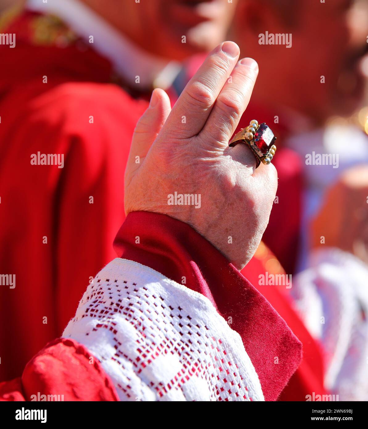 hand of the priest with a ring with a large red ruby while giving the ...