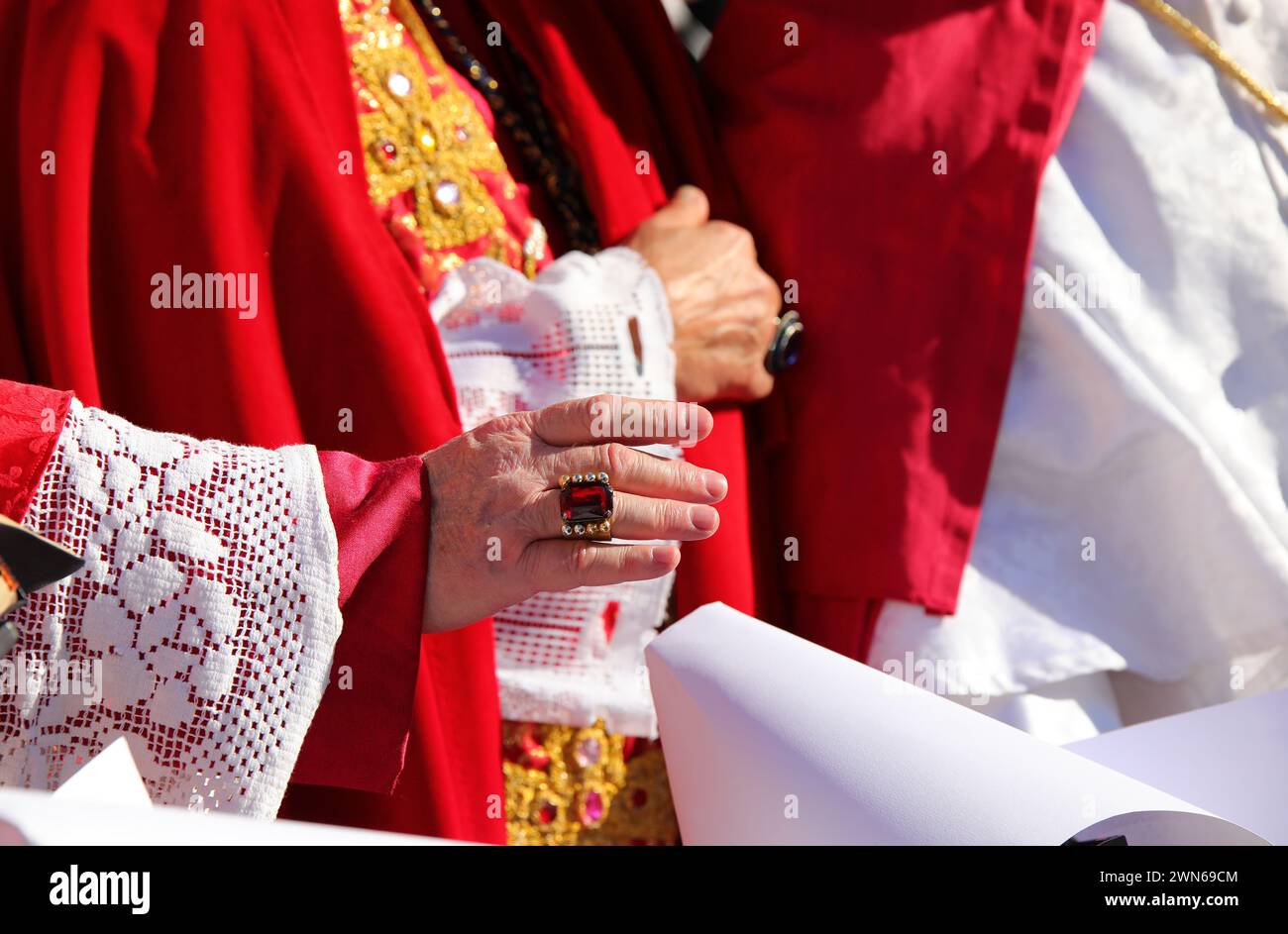 hand of the priest with a ring with a red ruby while giving the ...